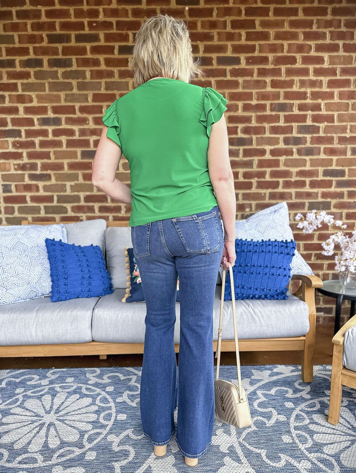 Wearing A Green Top With Flare Jeans For Spring